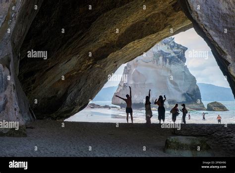 Tourists Posing For Photographs At Cathedral Cove Coromandel Peninsula