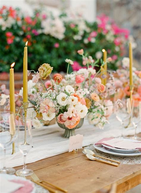 The Table Is Set With Flowers And Candles