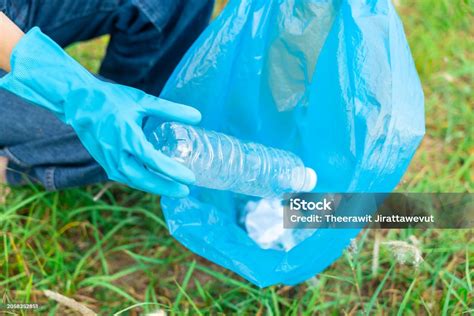 자원 봉사 자선 및 깨끗한 환경 개념 공원이나 길가의 쓰레기 봉투 청소 구역에 플라스틱 병 비닐 봉지 폐지를 모으는 자원 봉사자의 클로즈업 25 29세에 대한 스톡 사진 및