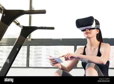 Beauty Asian Woman Rest On Treadmill With Virtual Reality Control By Smartphone Vr Headset