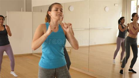 Portrait Of Cheerful Girl Practicing Vigorous Jive Movements In Group Dance Class Stock Video
