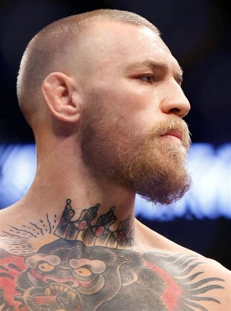 A Man With Tattoos On His Neck And Chest