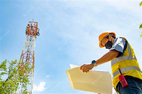 Premium Photo Male Architect Engineer Helmet Holding Blueprints Inspecting Telecommunication