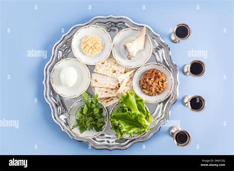 A Pesach Plate With Traditional Symbols Of The Jewish Passover And Four Glasses Of Red Kosher