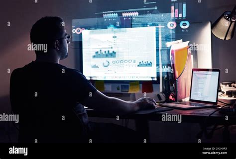 Integrating New Code Cropped Shot Of A Young Computer Programmer Looking Through Data Stock