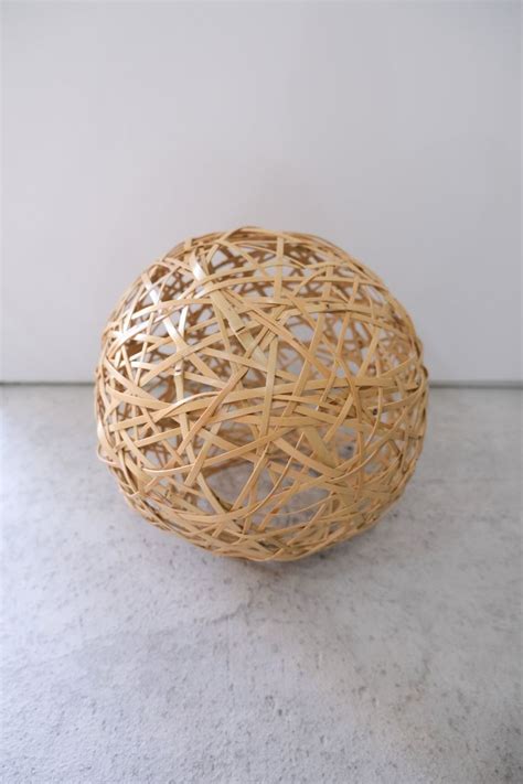 A Wooden Ball Sitting On Top Of A White Floor