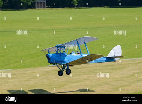 Vintage Tiger Moth Plane Taking Off From The Grass Airstrip At A Wings