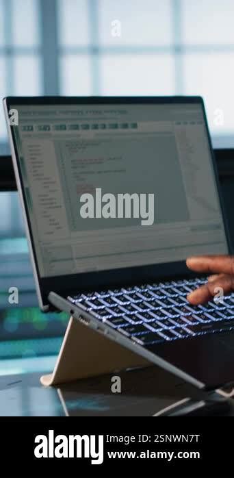 Vertical Video Engineer In Data Center With Laptop Automating Routine