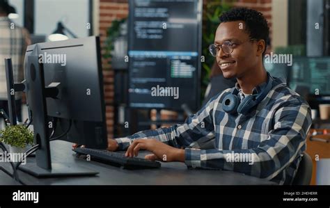 Portrait Of Software Engineer Writing Code Arranging Glasses And Being