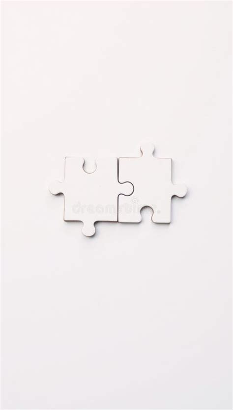 two interlocking jigsaw puzzle pieces against a white backdrop a