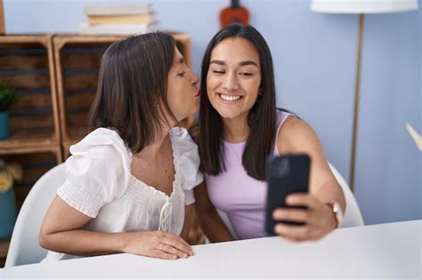 Two Women Mother And Daughter Make Selfie By Smartphone At Home