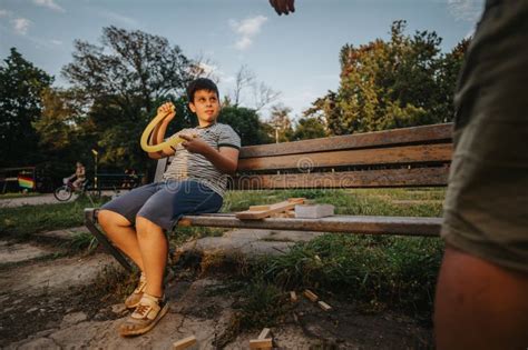 Father And Son Enjoying Building Games On A Park Bench Outdoors Stock Image Image Of Learning
