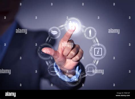 Business Person Pushing Symbols On A Touch Screen Interface Stock Photo