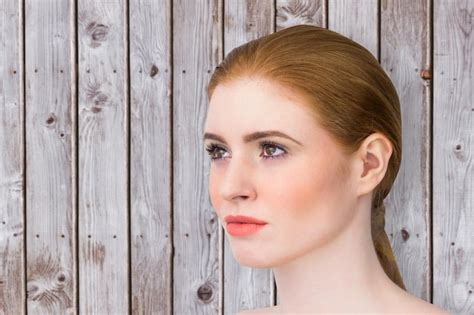 Premium Photo Beautiful Redhead Posing With Hair Tied Against Wooden Planks