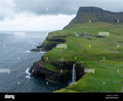 Aerial View Of Gasadalur Village And Mulafossur Waterfall In The Faroe
