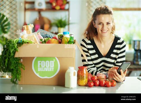 Food Delivery Smiling Middle Aged Housewife With Food Box Using