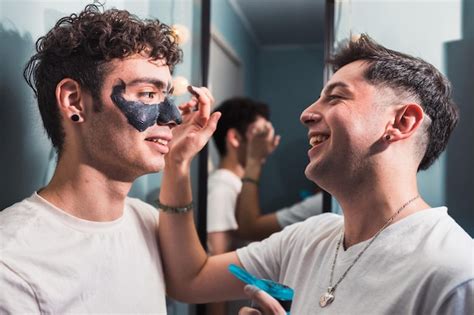 Premium Photo Portrait Of Young Gay Couple Applying Facial Clay Mask