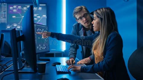 Male And Female Programmers Talking About Work Solving Problems Together Using Computers