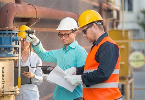 Babe Men And A Woman Are Standing Near A Gas Pipe With An Analyzer And Documents They Are