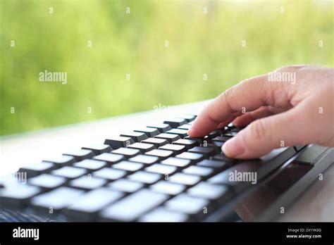 Close Up Female Hand Typing Text On A Computer Keyboard On A Natural Background Workplace