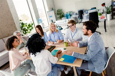 Diverse Team Collaborating In A Modern Office Environment During A Business Meeting Stock Image