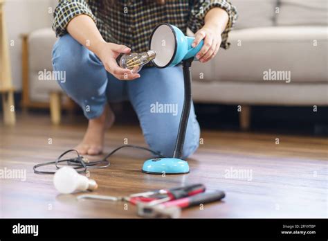 Asian Woman Changing Light Bulb In Lamp Renovation Using Equipment To Diy Repairing Light Bulb