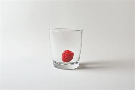 Minimalist Raspberry Water Glass With A Single Raspberry White Background Premium Ai Generated