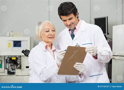 Technicians Writing On Clipboard In Laboratory Stock Image Image Of