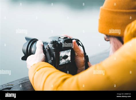 Photographer Using The Rear Lcd Screen To Compose And Take A Landscape Photo Stock Photo Alamy