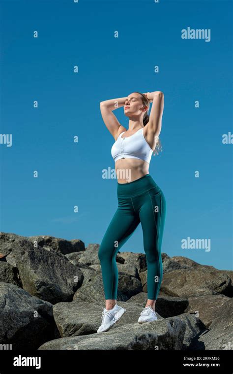 Sporty Woman With Hands On Her Head Stretching Exercise Outside In The