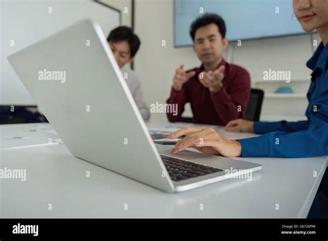 Focused Discussion And Design Review Team Members Discussing Ux Strategies While Referencing