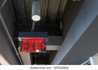 Red Exit Sign Hanging Ceiling Looking Stock Photo 1337620826 Shutterstock