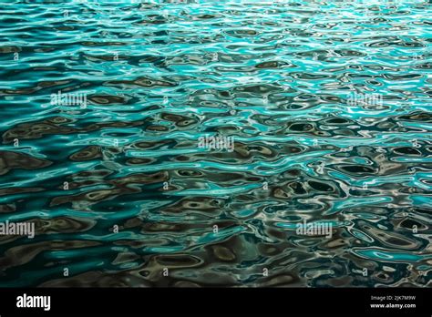 Water Ripple Texture Background Wavy Water Surface During Sunset Golden Light Reflecting In