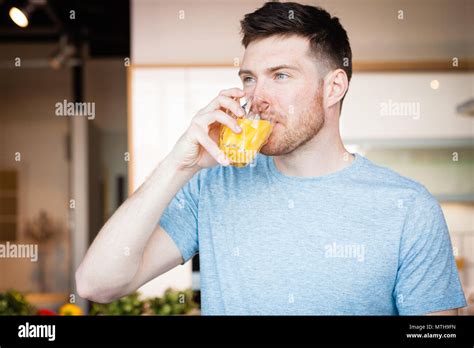 Man Drinking Orange Juice Stock Photo Alamy