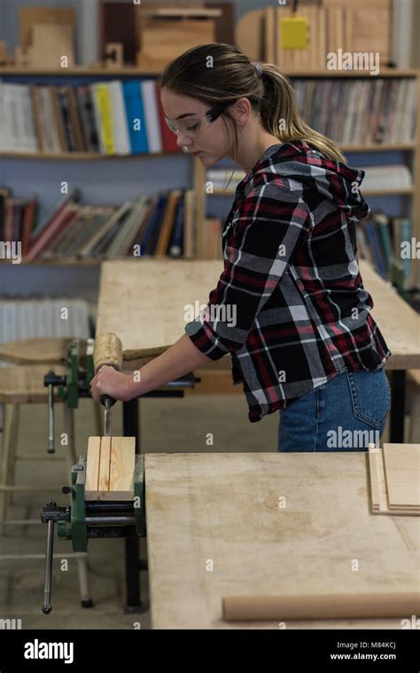 Female Carpenter Using Chisel With Hammer On A Piece Of Wood Stock Photo Alamy