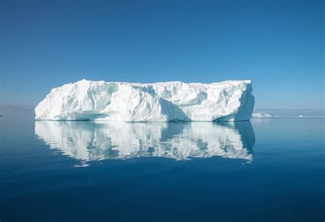 Glacial Icebergs Floating On A Calm Blue Arctic Ocean Surface Stock