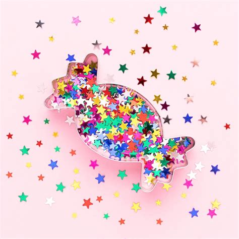 Premium Photo Decorative Candy Made Of Colorful Confetti At Pastel Pink Background