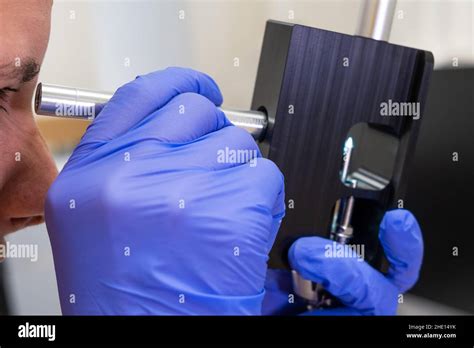 Scientist Checking The Condition Of Nebulizer Needle From Lc Ms Qtof System Using Adjustment