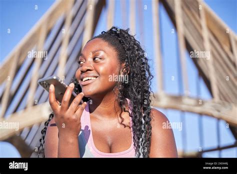 Happy Young African American Woman Recording And Sending Audio Message On Mobile Phone Using