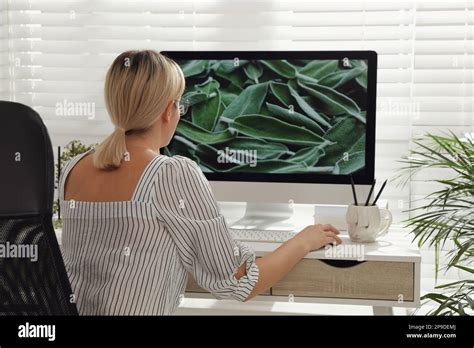 Woman Working On Computer At Table In Room Back View Interior Design Stock Photo Alamy