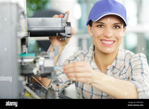 A Woman Fixing A Printer Stock Photo Alamy