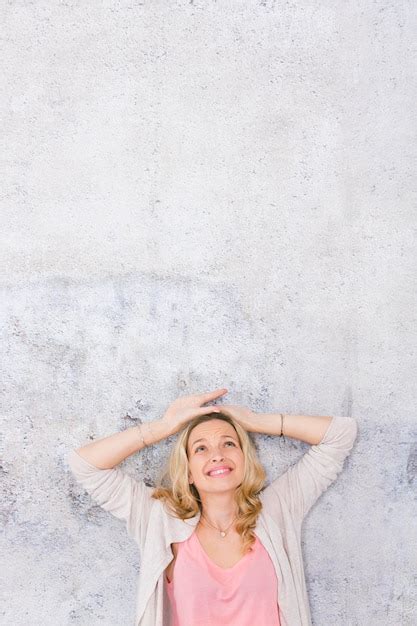 Premium Photo Woman Looking Up Against Wall