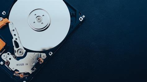 Premium Photo Disassembled Open Hard Disk Drive Hdd Of Computer Or Laptop Lies On Dark Matte