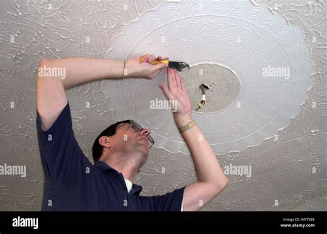 An Electrician Installing A Ceiling Light Fitting Stock Photo Alamy
