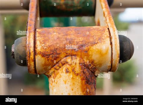 A Rusty Metal Object With A Green Handle The Object Is Old And Has A Worn Appearance The Rust