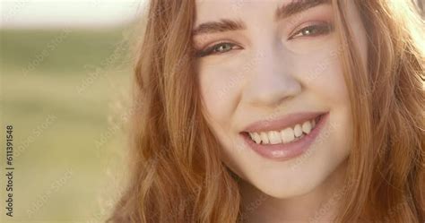 Cute Ginger Woman With Long Red Hair On Field Looking At Camera Happy