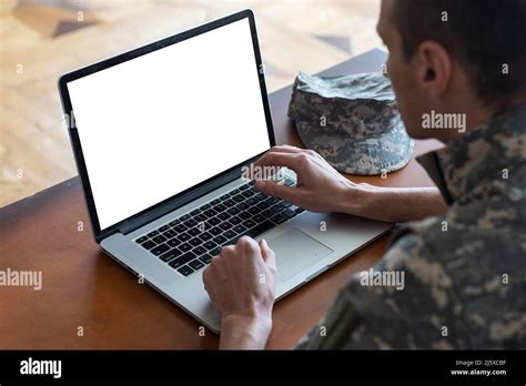 Army Young Soldier Working With A Laptop Computer With Blank Screen On Black Background Stock