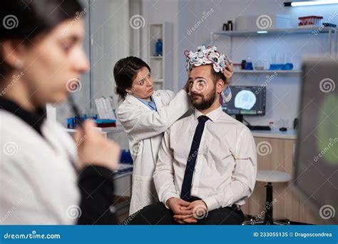 Specialist Researcher Woman Putting Eeg Headset On Man Patient Analyzing Brain Evolution Stock