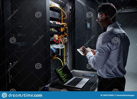 Network Engineer Using Laptop While Setting Up Servers In Data Center Stock Image Image Of