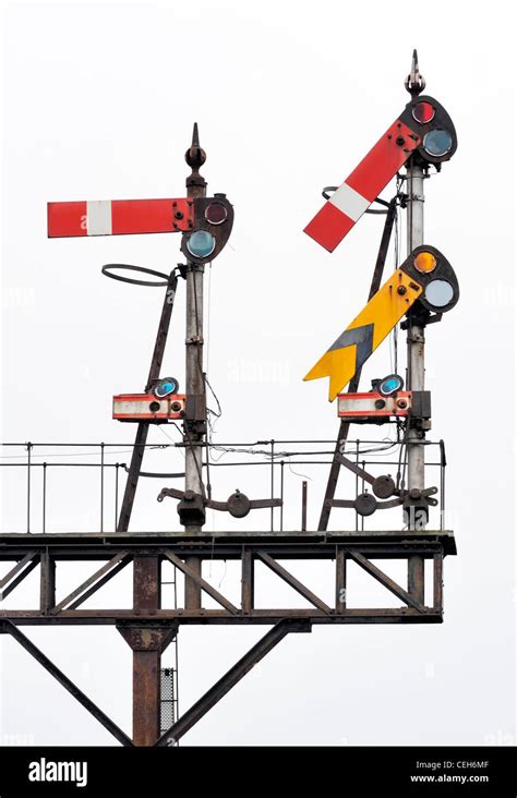 Closeup On Traditional English Semaphore Railway Signals On Gantry On Closeup On Traditional English Semaphore Railway Signals On Gantry On